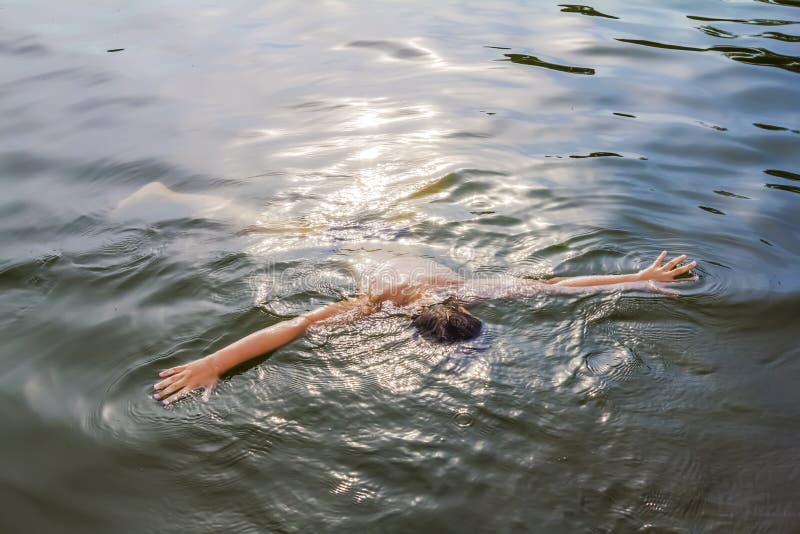 The Boy Lay on the Water in the Lake on a Summer Day Stock Photo ...