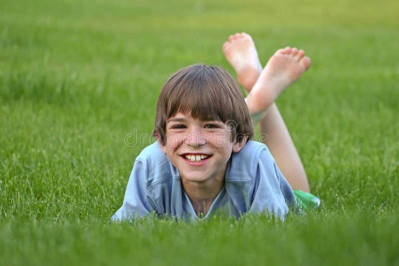 Boy laying in Grass stock photo. Image of life, portrait - 2417102