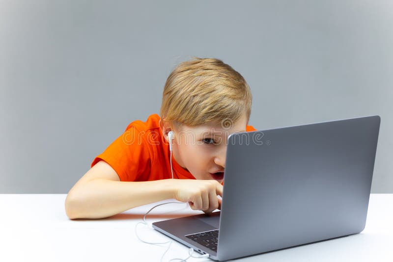 The Boy Leaned Over To the Laptop and Diligently Types on it Stock ...