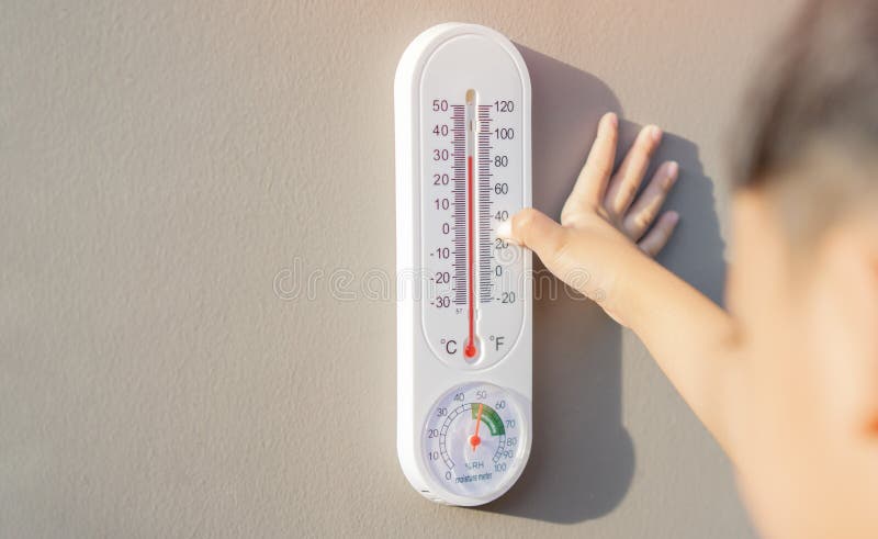The Boy Learn To Checking the Numbers on a Thermometer on a Gray Wall ...
