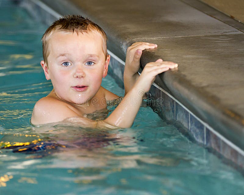 Boy learning how to swim stock photo. Image of energetic - 99585010