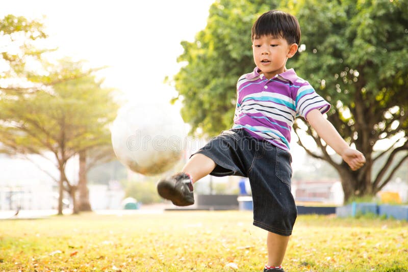 Boy Learning Kick Ball at the Park in the Evening Stock Image - Image ...