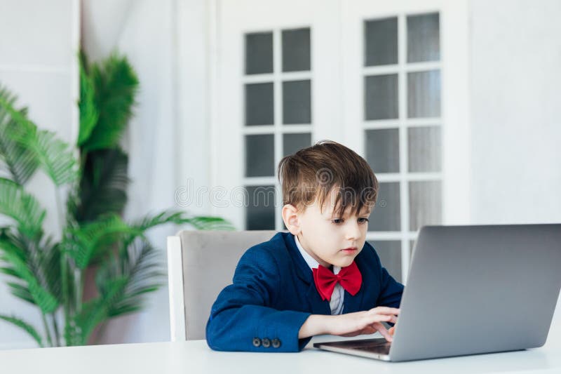 Boy Learning Online with a Laptop at a Table at Home Stock Photo ...