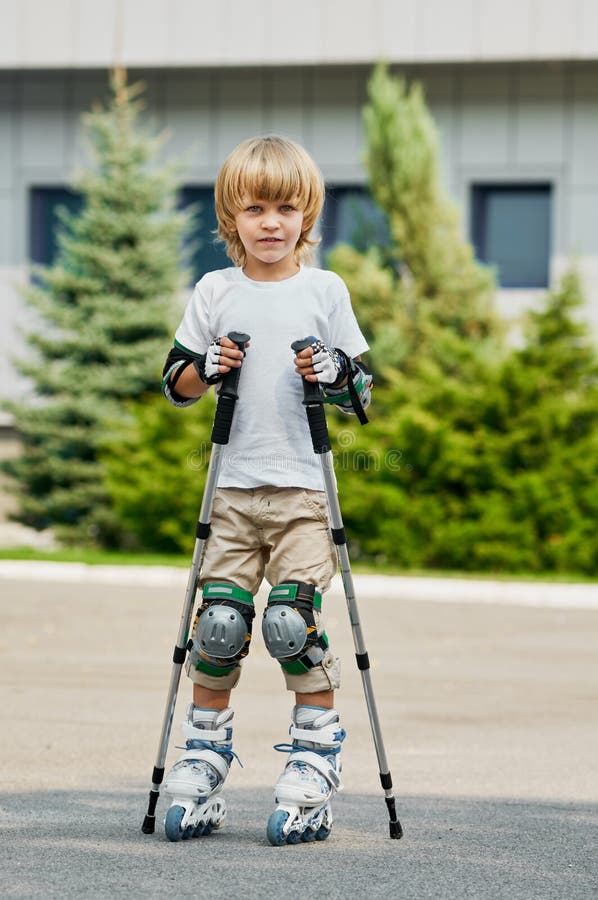 Boy learning rollerblading stock image. Image of poles - 109265283