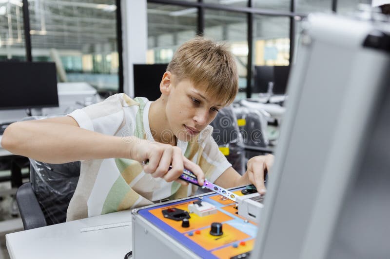 Boy Learning To Repair Electrical Appliances. Education on Table at ...