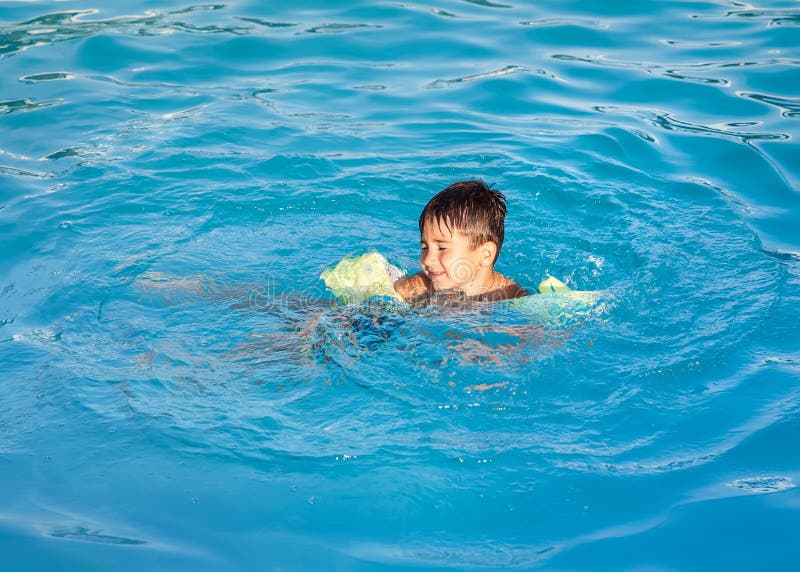 Boy Learning To Swim in the Pool Stock Photo - Image of inflatable ...