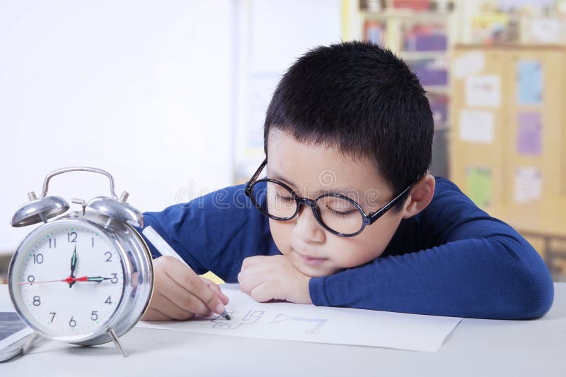Boy Learns in Class with Alarm Clock Stock Photo - Image of adorable ...