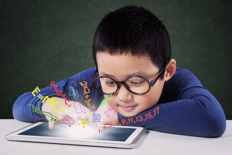 Boy Learns with Tablet on Desk in Class Stock Image - Image of glasses ...
