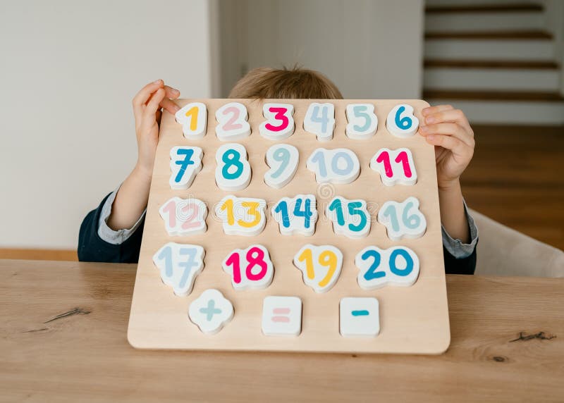 The Boy Learns To Count, Holds a Board with Numbers-puzzles Arranged in ...