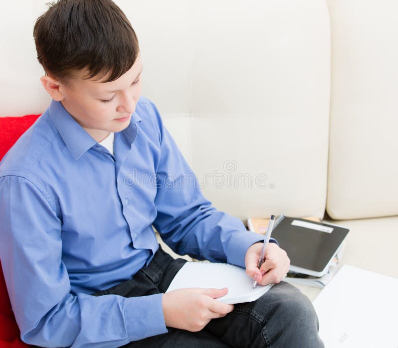 The Boy is Left-handed Writing in a Notebook Stock Photo - Image of ...