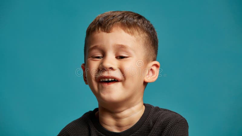 Boy Lets Out Soft Chuckle, Satisfied and Light-hearted Expression on ...