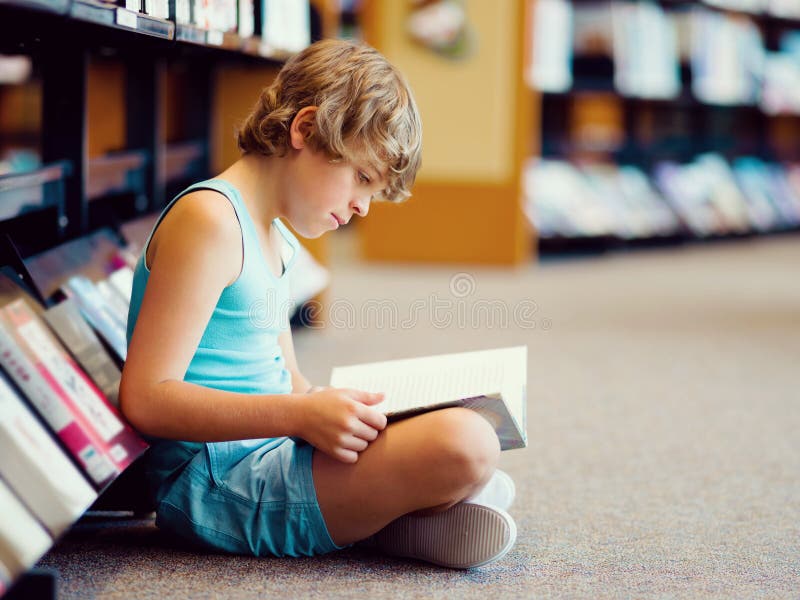 Boy in library stock image. Image of book, elementary - 100986817