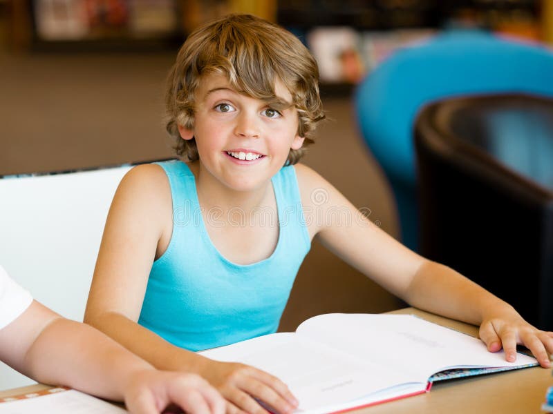 Boy in library stock image. Image of elementary, cheerful - 53125575