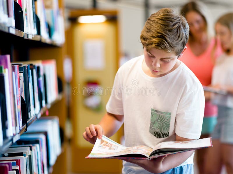 Boy in library stock photo. Image of books, pupil, book - 56306928