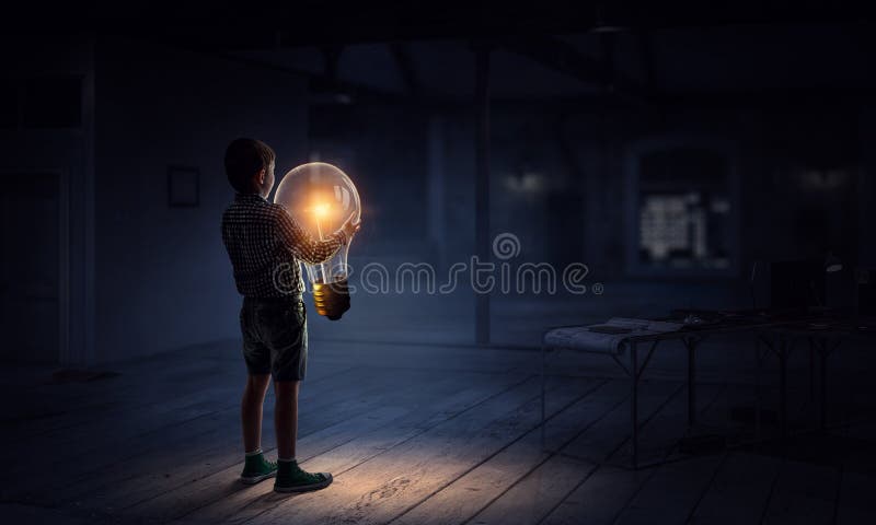 Boy with a light bulb stock photo. Image of concept - 189051400