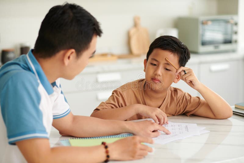 Boy Listening To Father Explaining Topic Stock Image - Image of ...