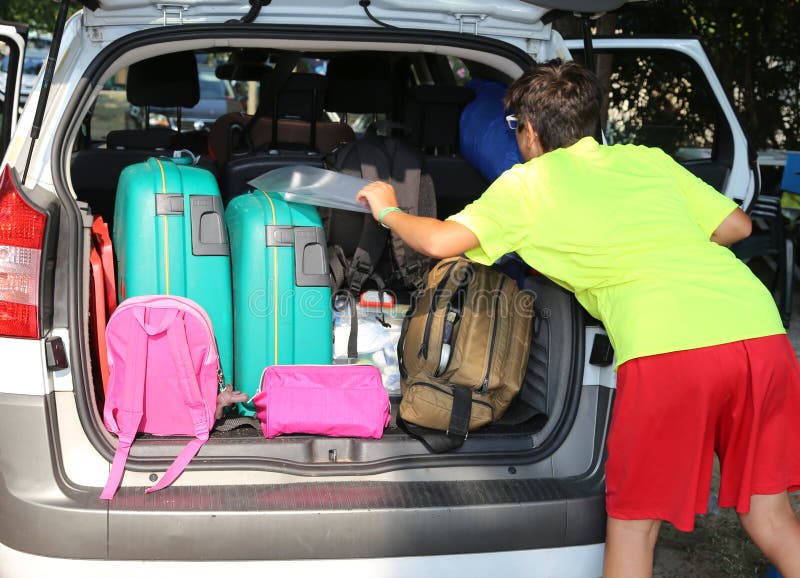 Boy Loads the Luggage in the Trunk of the Car Stock Image - Image of ...