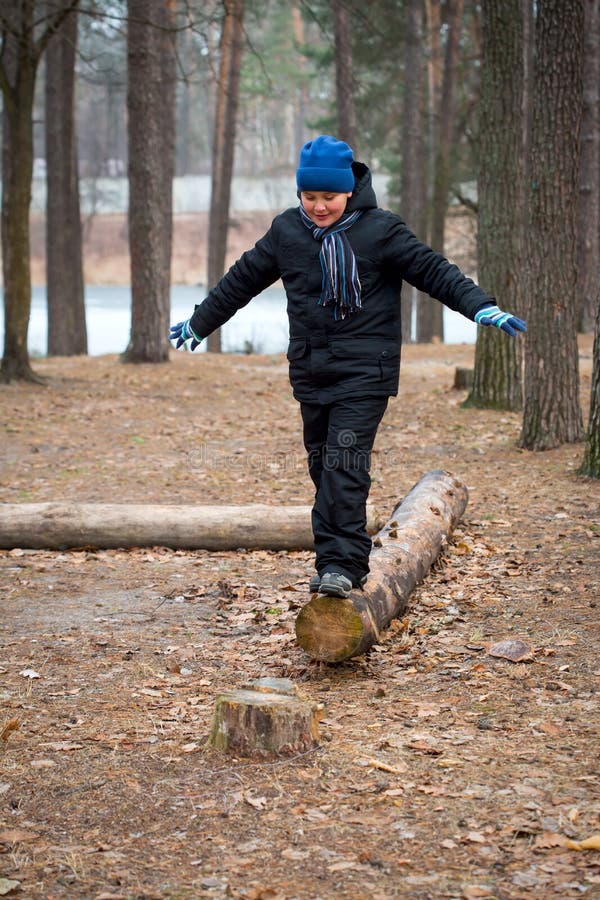 A boy on a log stock image. Image of country, winter - 80743853