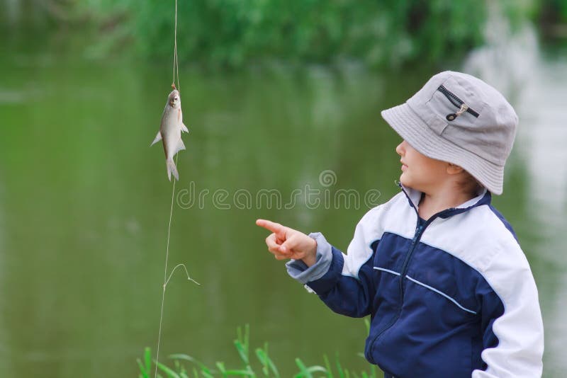 Boy Look at the Caught Fish Stock Photo - Image of fisherman ...