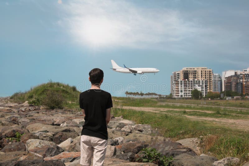 Boy Looking at Airplane Flying, Back View Stock Photo - Image of blue ...