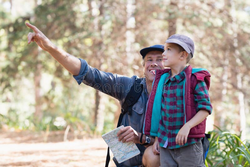 Boy Looking Away while Father Pointing Stock Image - Image of forest ...