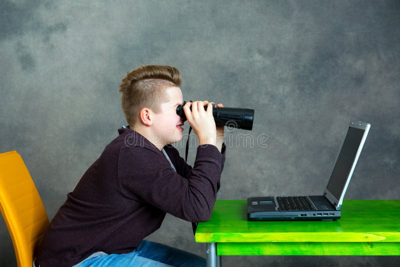 Boy Looking through a Binoculars at the Computer Stock Image - Image of ...