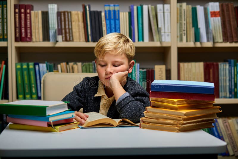 Boy Looking Bored while Studying at the Library Stock Image - Image of ...