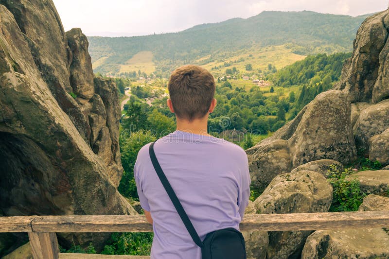 The Boy is Looking into the Distance from the Mountain. Stock Image ...