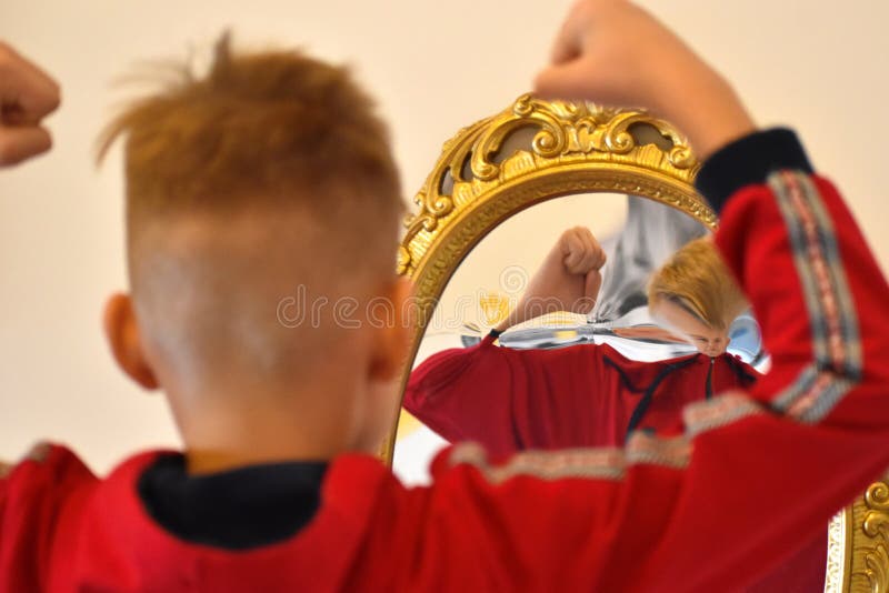 The Child Reflected in a Distorting Mirror. a Fun Reflection of the Boy ...