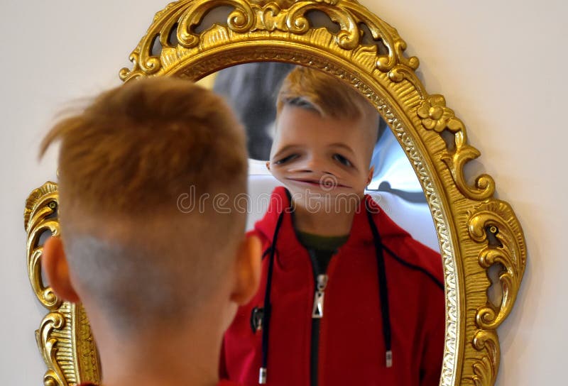 The Child Reflected in a Distorting Mirror. a Fun Reflection of the Boy ...