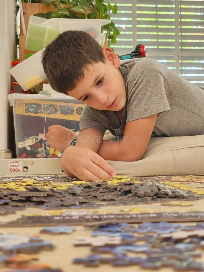 Boy Looking at a Jigsaw Puzzle Stock Image - Image of artist ...