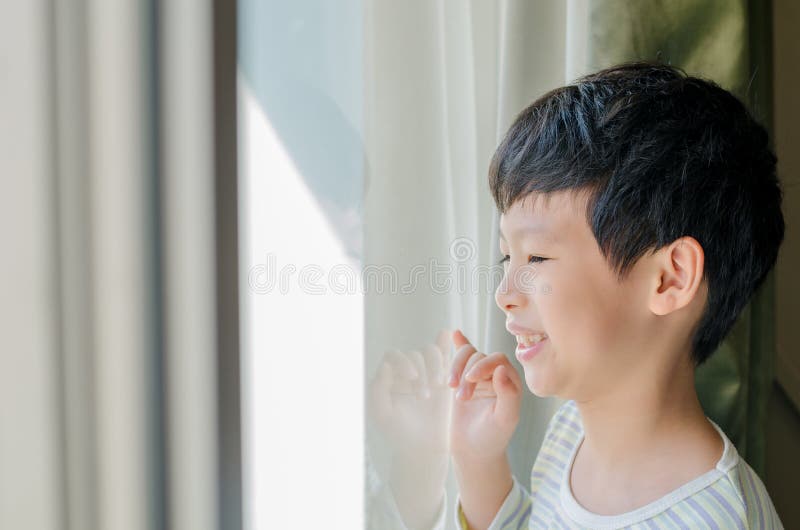 Boy Looking Out of Window and Smiles Stock Image - Image of asian ...