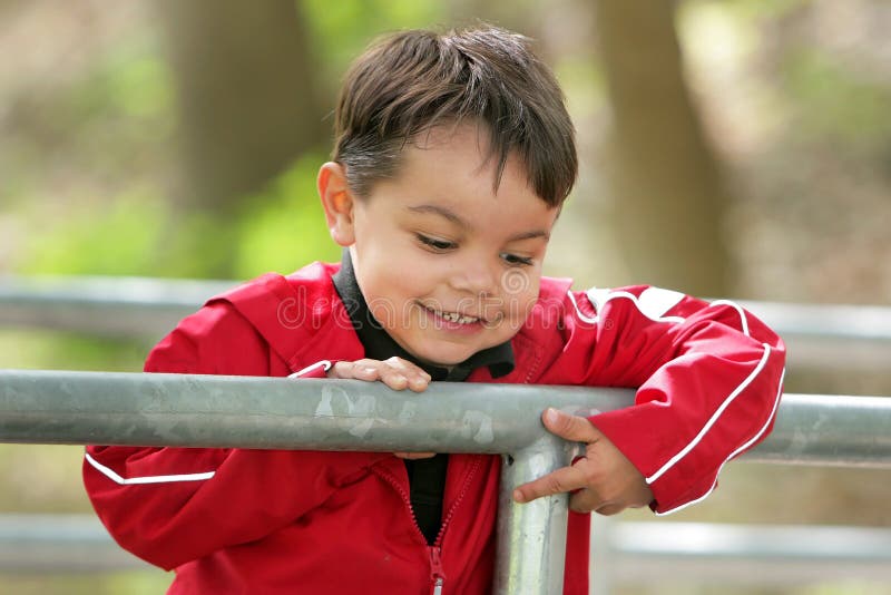 Boy Looking Over a Railing at a Bridge Stock Photo - Image of curious ...
