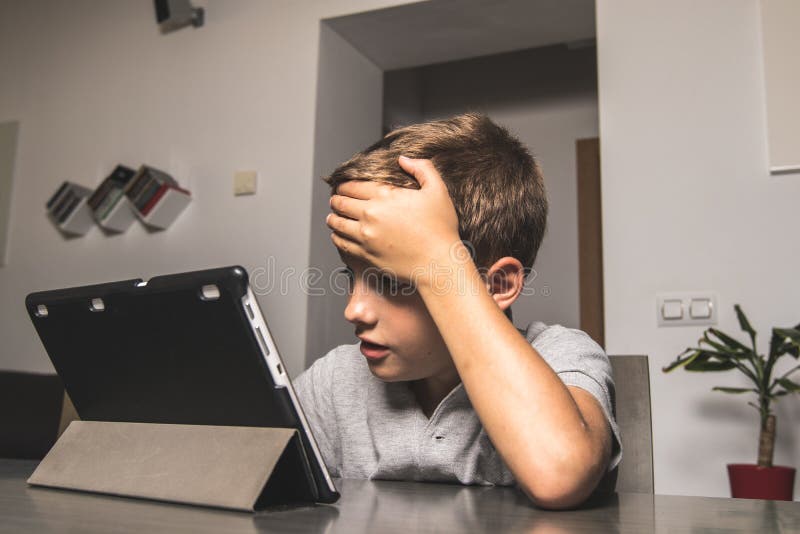 Child Looking at a Tablet with Frustrated Expression Stock Image ...