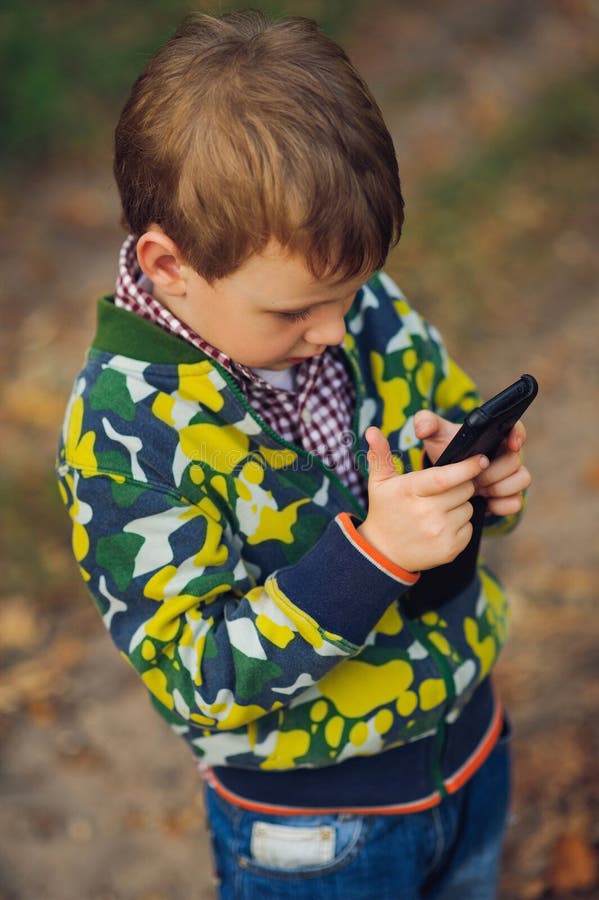Boy Looking To Smartphone in Your Hand Stock Image - Image of attentive ...