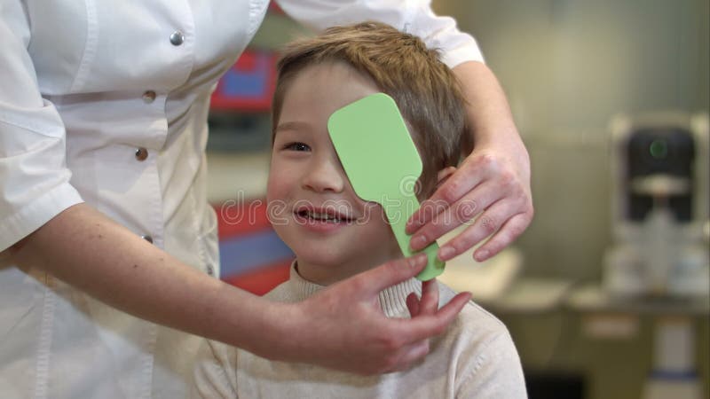 Boy Looking at Vision Test with One Eye Covered with Occluder Stock ...