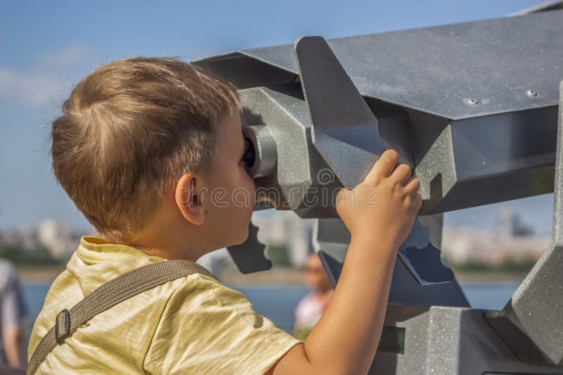 The Boy Looks through Binoculars from the Observation Deck. Journey ...
