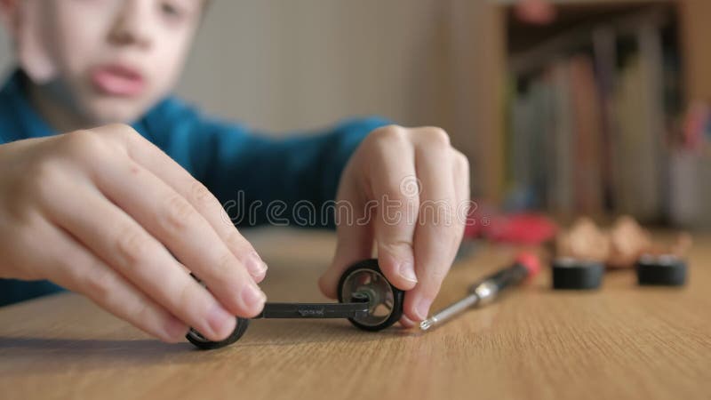 The Boy Looks How Work Wheels the Swivel on Model Supercar Stock Video ...