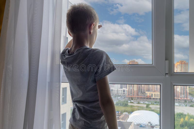 Boy Looks Out Window at City, Dreaming of Future. Self-knowledge in Pre ...