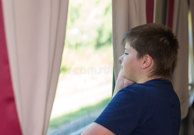 The Boy Looks Out the Window on Train Stock Photo - Image of window ...