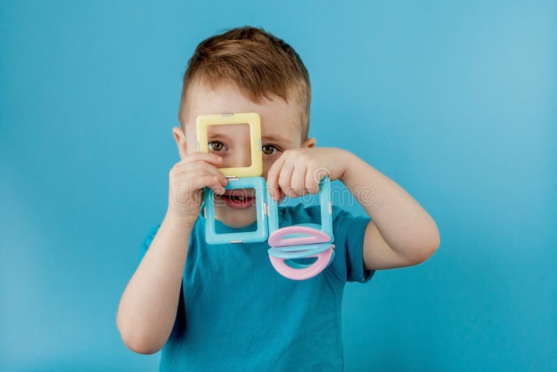 Boy Looks through the Shape in the Color Constructor with the ...