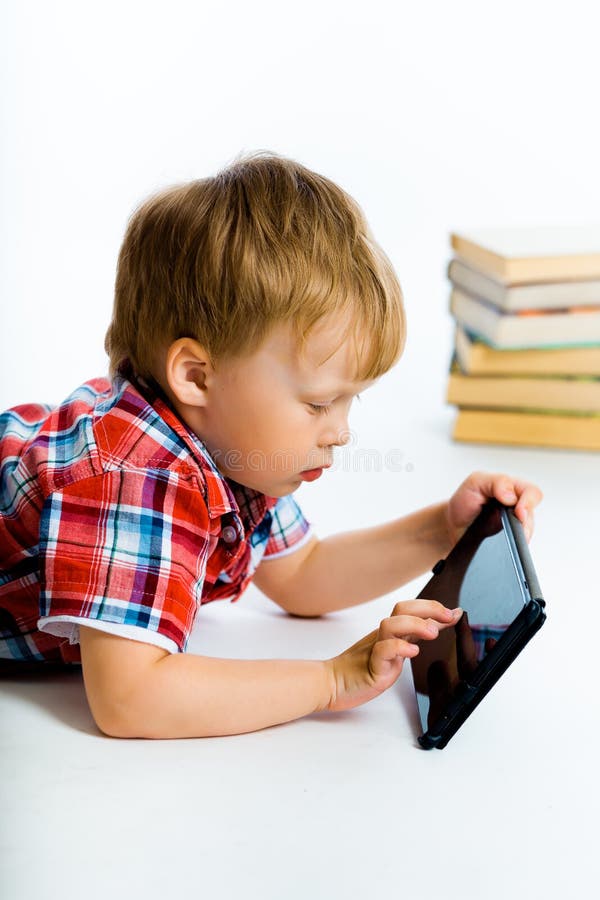 Boy Lying on the Floor with Tablet Computer Stock Photo - Image of ...