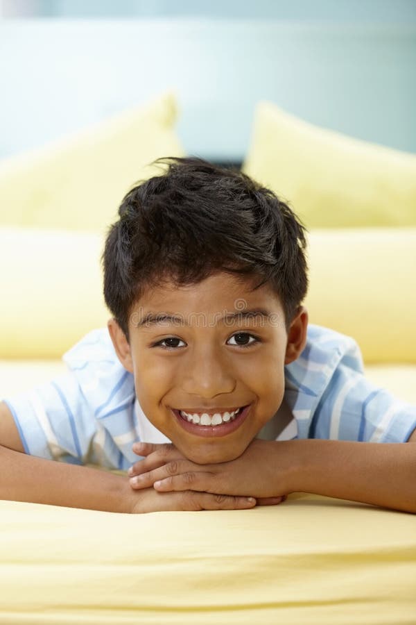 Boy Lying Forward in Bed Smiling. Conceptual Image Stock Image - Image ...
