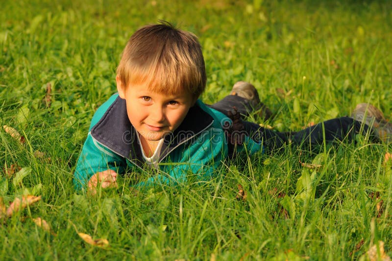 Boy lying on grass stock image. Image of green, lying - 29506163