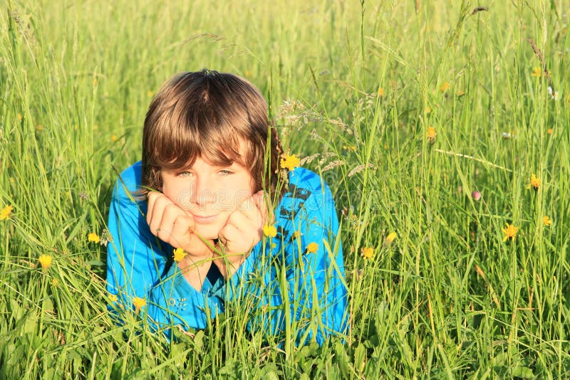 Boy lying in grass stock photo. Image of hiding, smile - 54697970