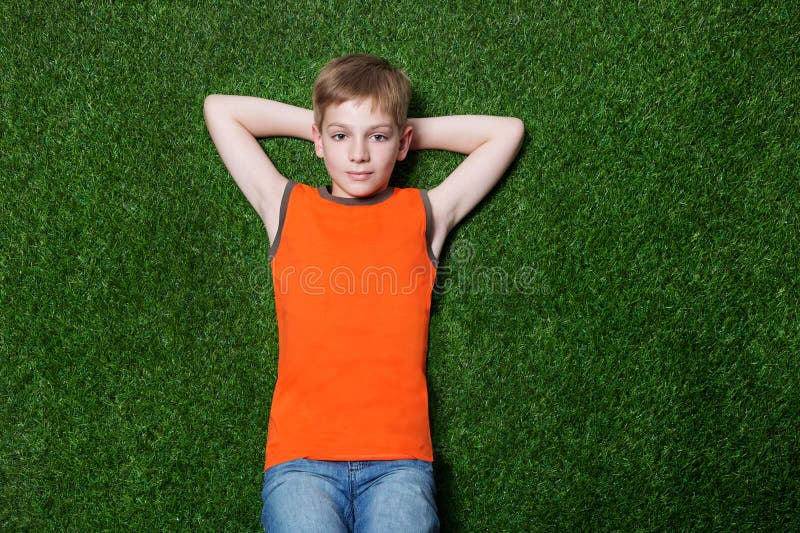Boy Lying with Pinwheel on Green Grass Stock Image - Image of male ...