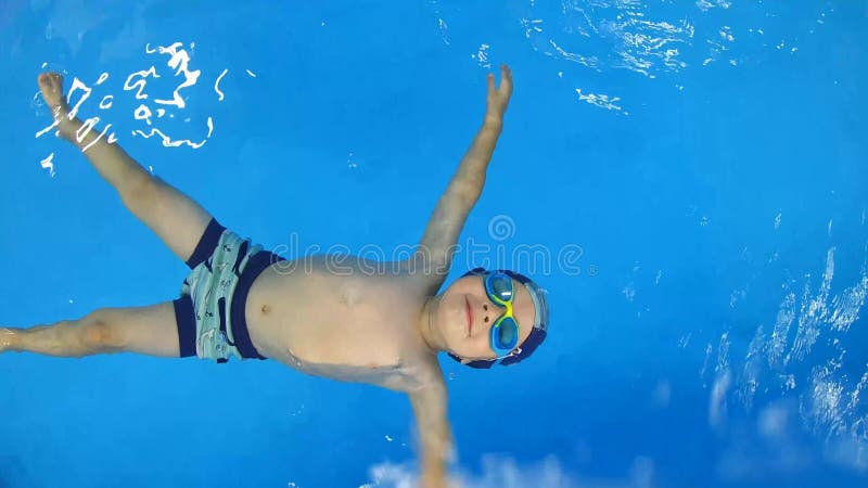 Boy lying on the pool stock video. Video of aquatherapy - 258149891