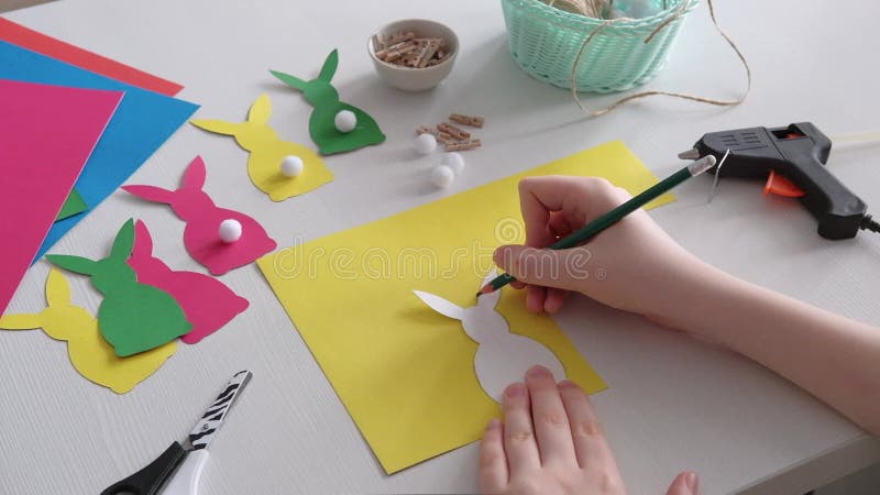 Boy Made Easter Paper Garland. Hands Trace Outline of Easter Bunny on ...