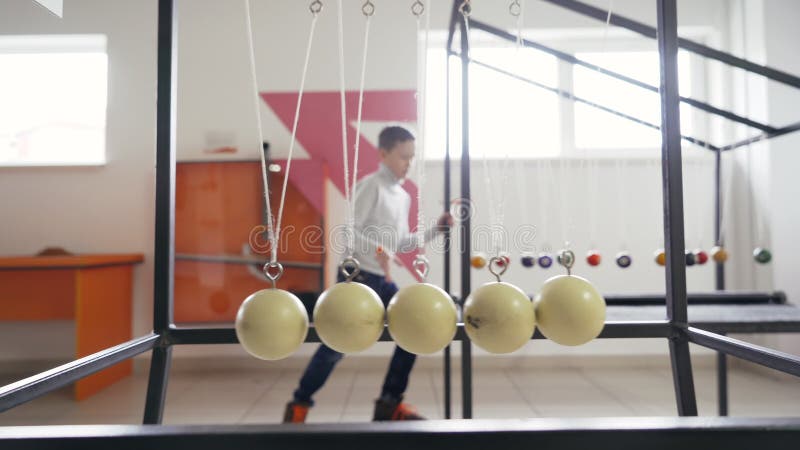 Boy Makes an Experiment with Newton S Pendulum. the Concept of Physics Stock Video - Video of ...