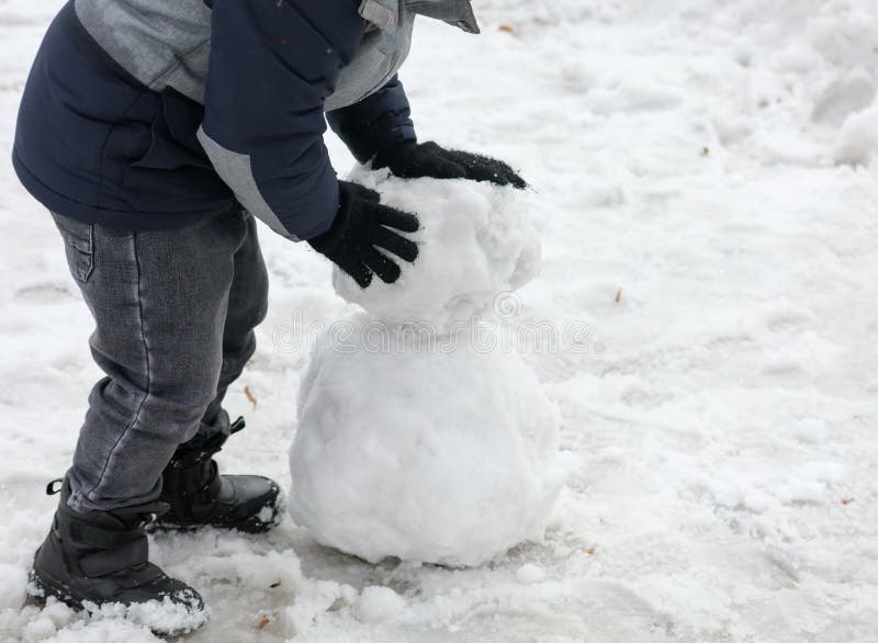 A Boy Makes Snow for a Snowman Stock Photo - Image of cute, lifestyle ...